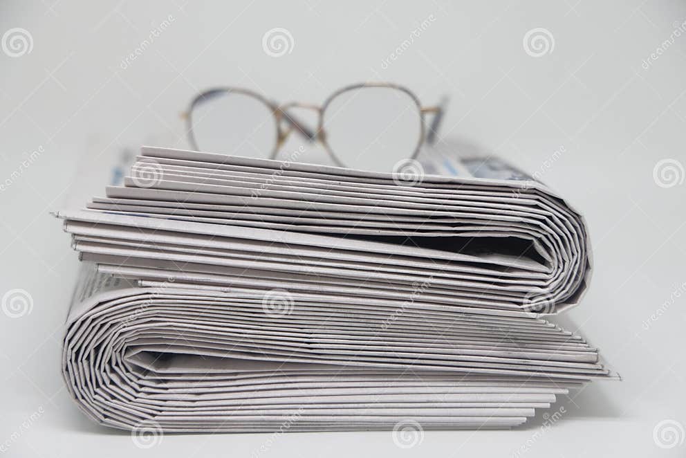 A Stack of Tabloid Format Folded Newspapers Isolated on White ...