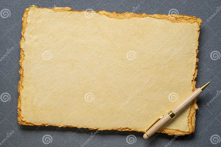 Stack of Tan Toned Heavyweight Deckle Edge Paper Sheets with a Pen ...