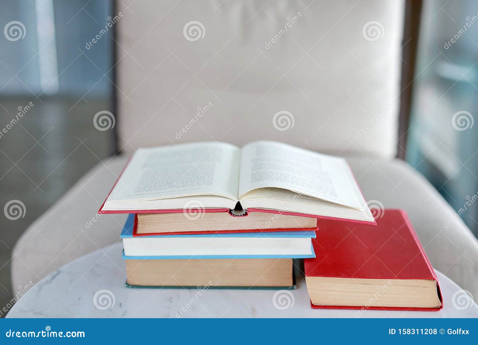Stack of Textbooks on Desk with Open Book on the Top in Library Room ...