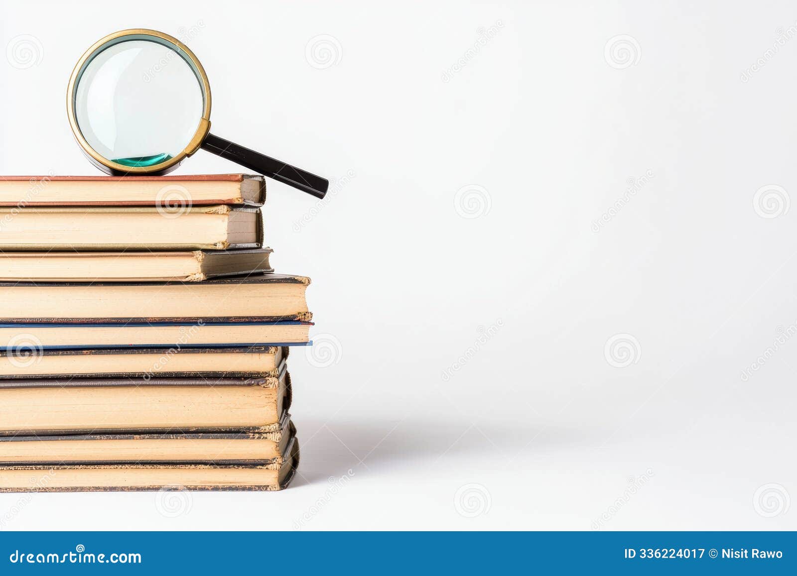 A Stack of Thick Encyclopedias with a Magnifying Glass on Top ...
