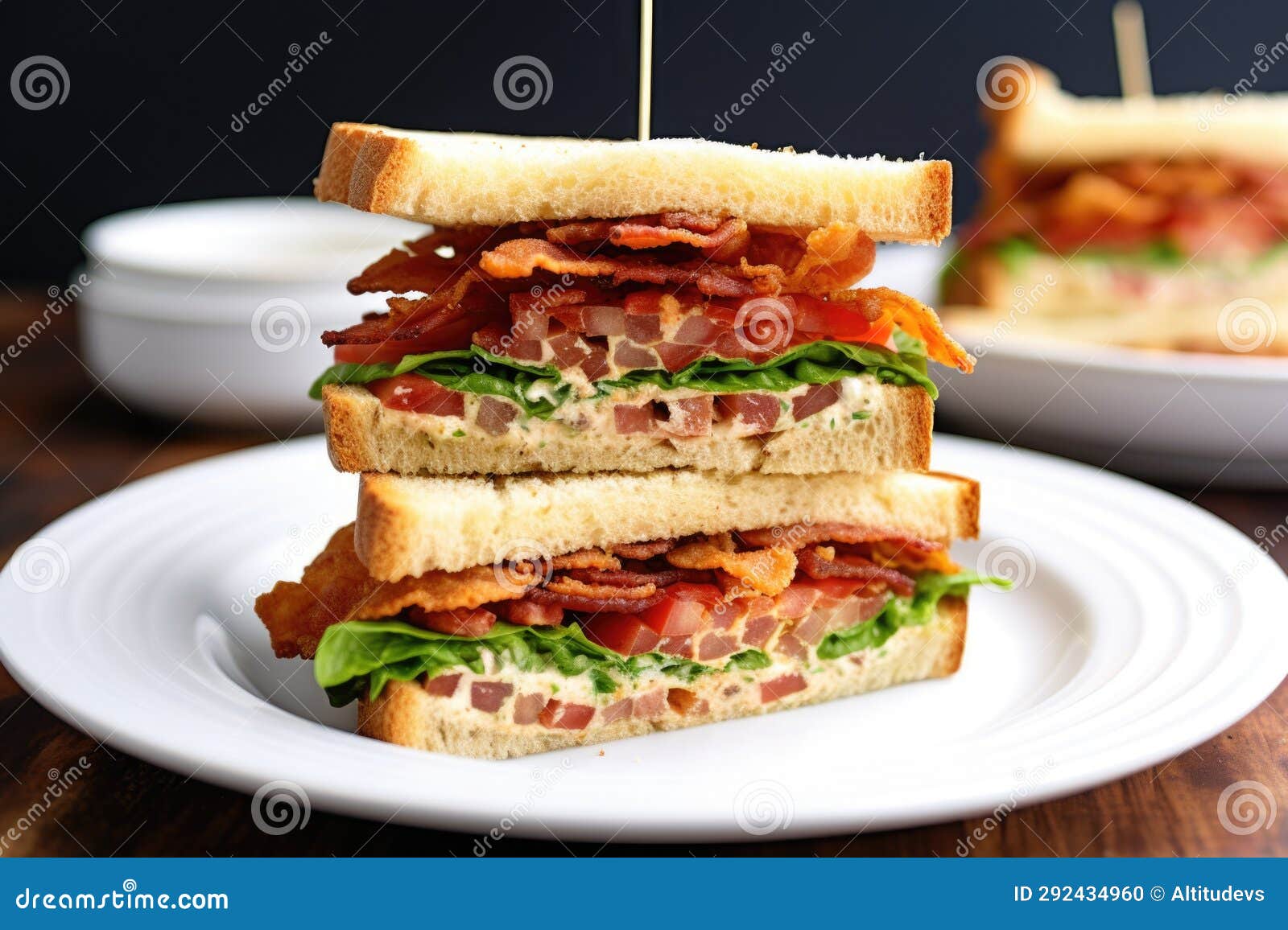 A Stack of Three Blt Sandwiches on a Rectangular Plate Stock ...