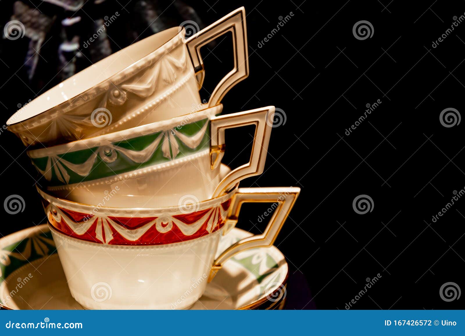 Stack of Three Elegant, Classic Style, Gilded Tea Cups on a Dark ...