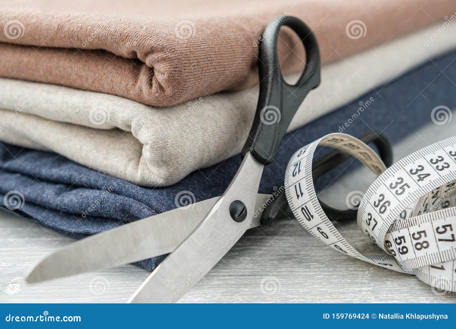 Stack of Three Knitted Fabrics, Scissors of Dressmaker and Measuring ...