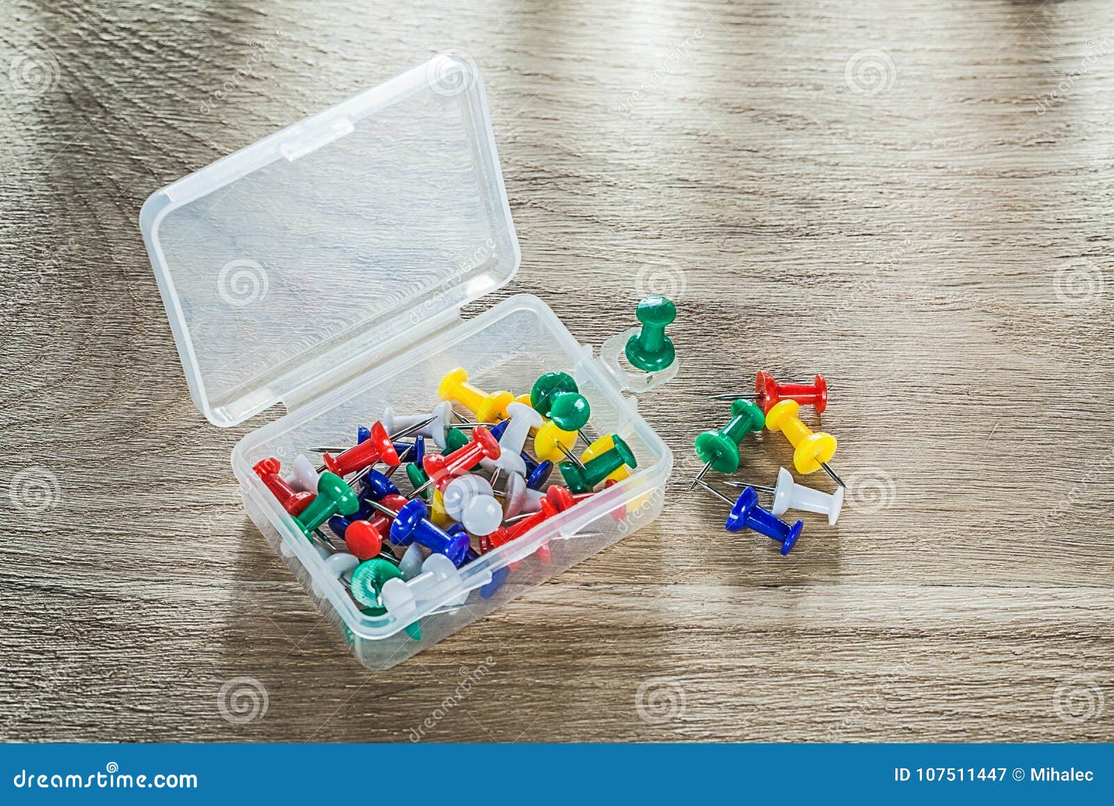 Stack of Thumbtacks in Plastic Container on Wooden Board Stock Image ...