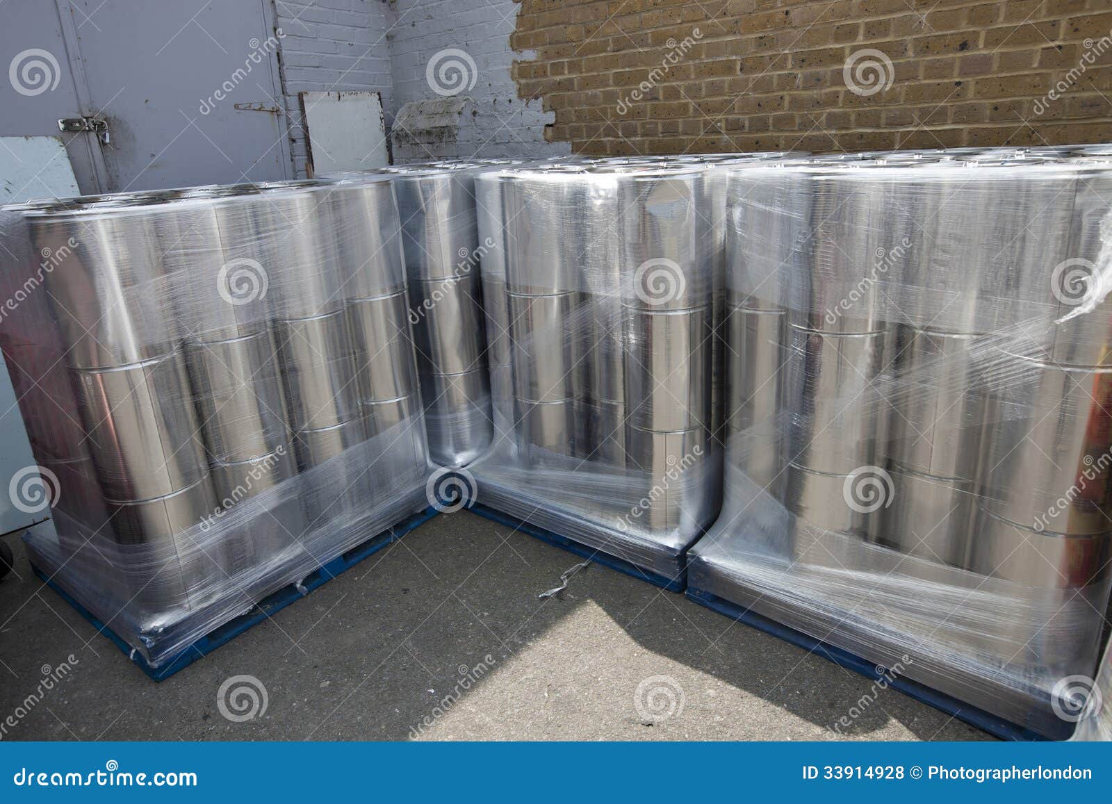 Stack of Tins Outside Warehouse Stock Photo - Image of wrapped ...