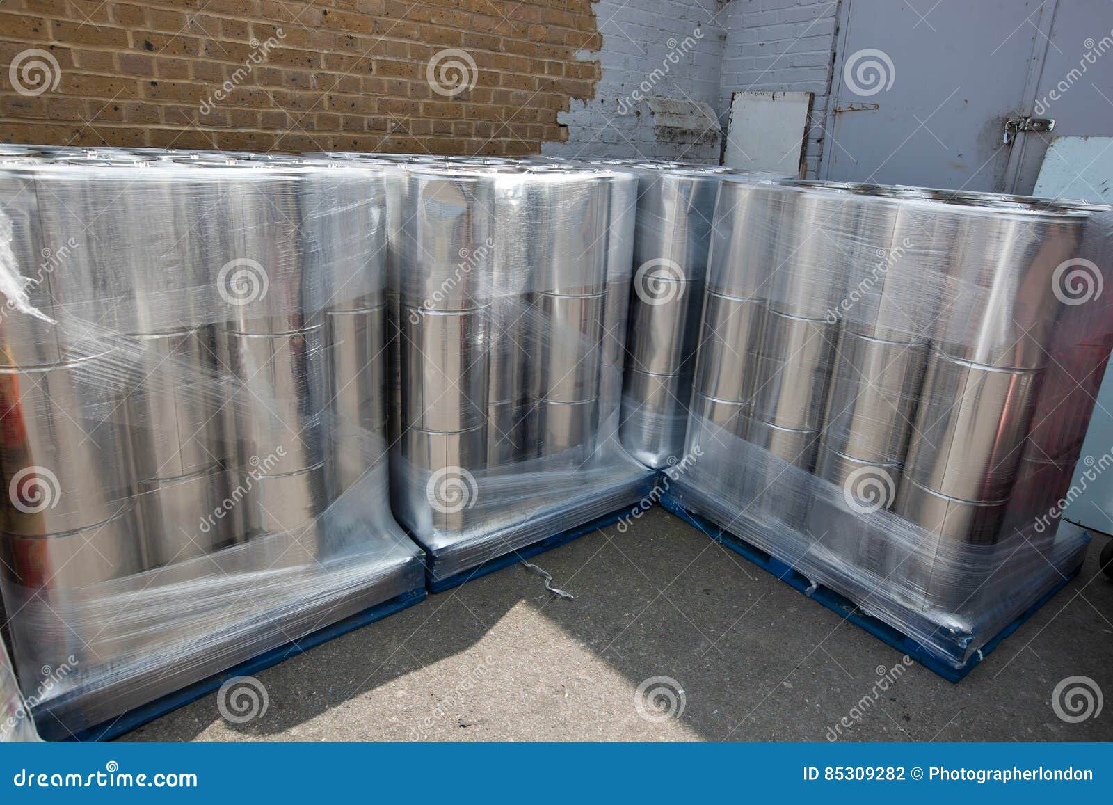 Stack of Tins Outside Warehouse Stock Photo - Image of wrapped, london ...