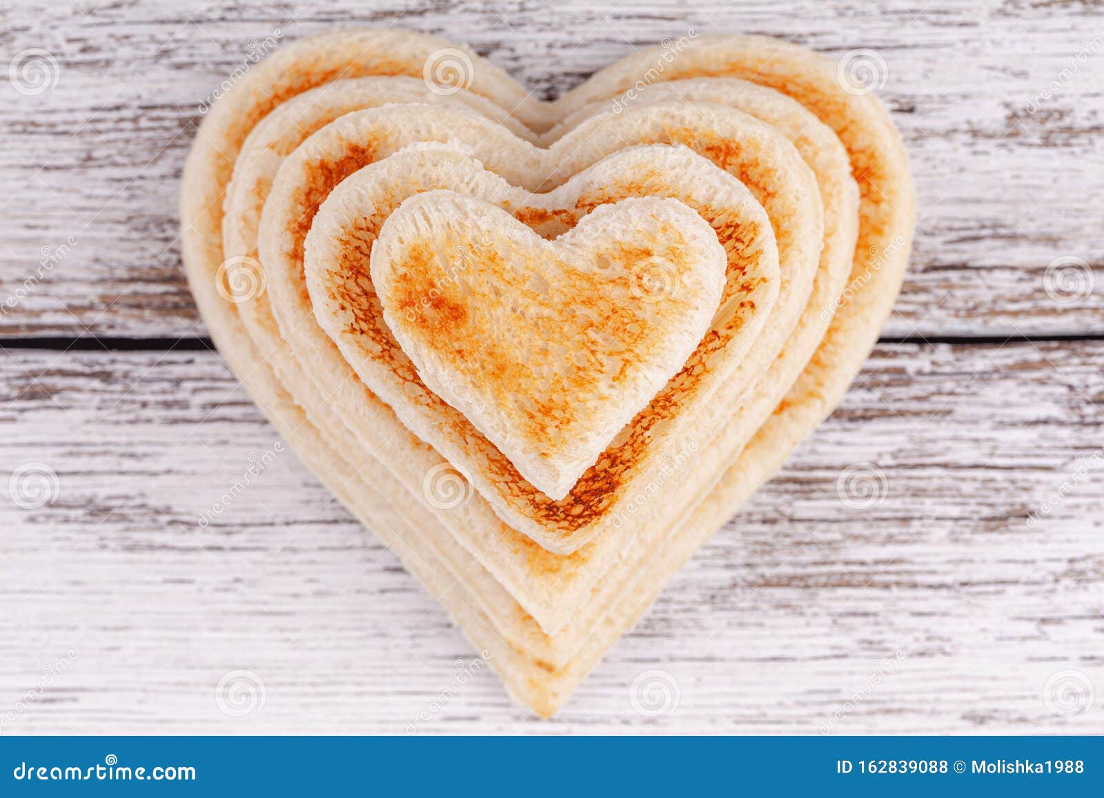 Stack of Toasted Bread Hearts on Wooden Table, Concept of Support in ...