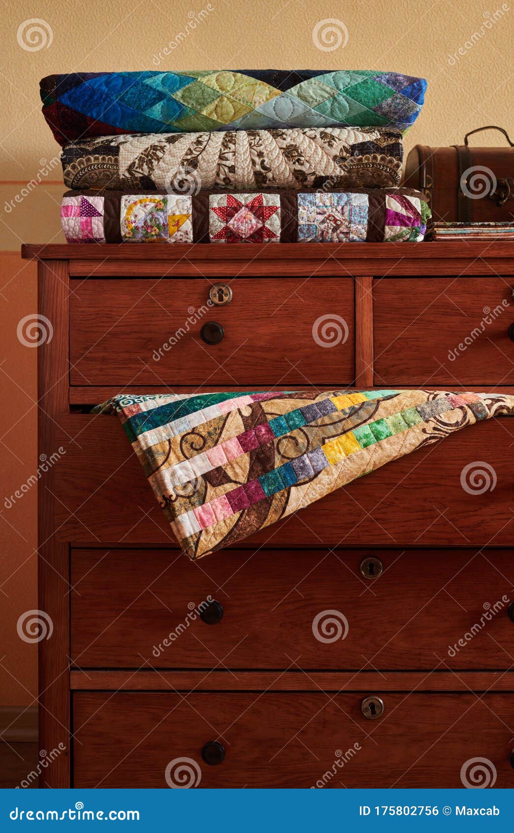 Stack of Traditional Quilts on Chest of Drawers Stock Photo - Image of ...