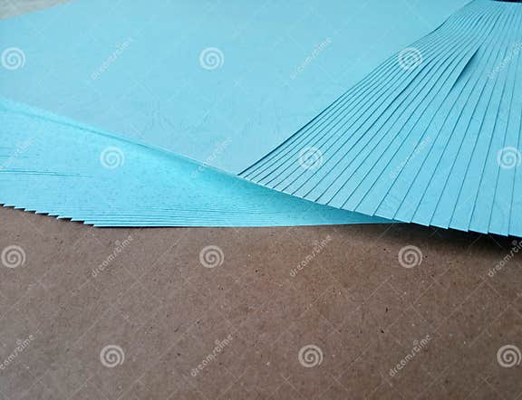 A Stack of Turquoise Cardboard on a Brown Board Stock Photo - Image of ...