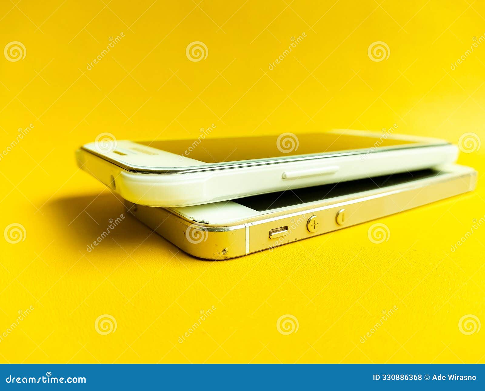 Stack of Two Mobile Phones on Yellow Background Stock Photo - Image of ...