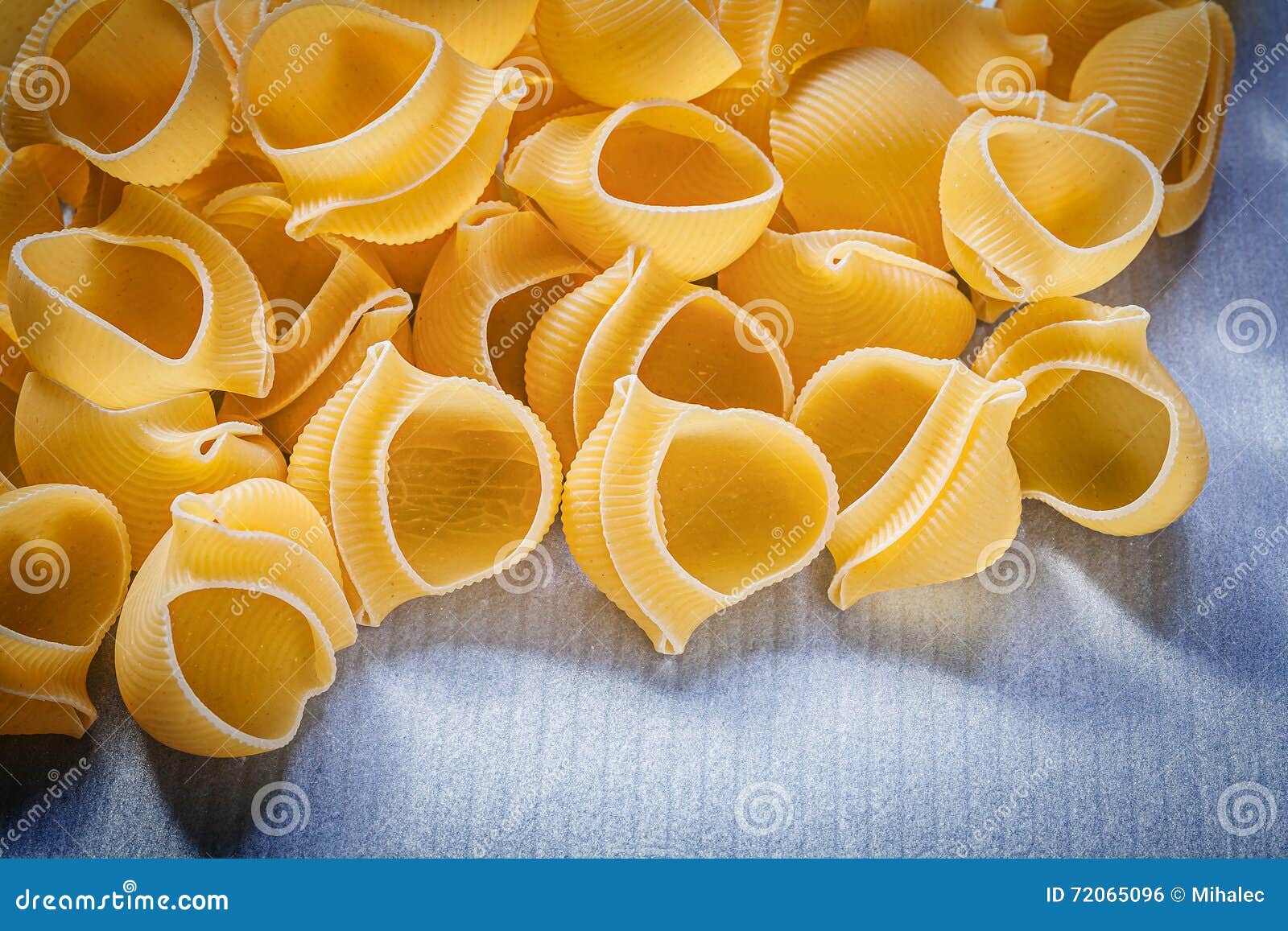 Stack of Uncooked Shell Macaroni on Blue Background Food and Dri Stock ...