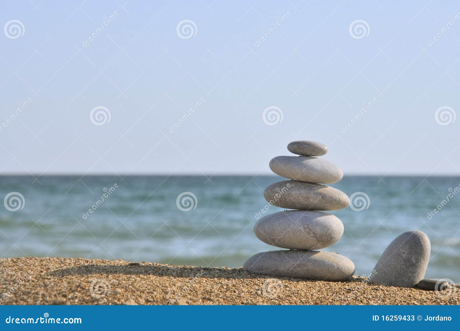 Stack of Volcanic Pebbles in Calm Water Stock Image - Image of water ...