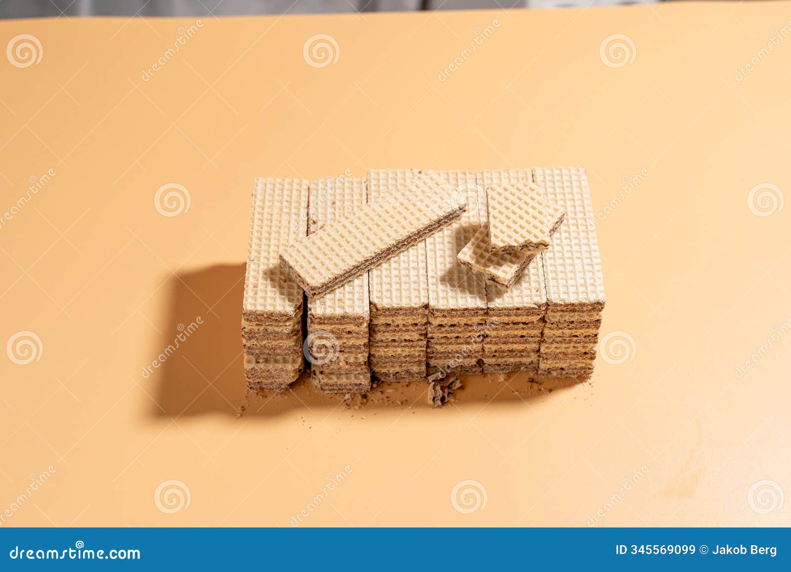 A Stack of Waffles with One Broken Piece on an Orange Background. Stock ...