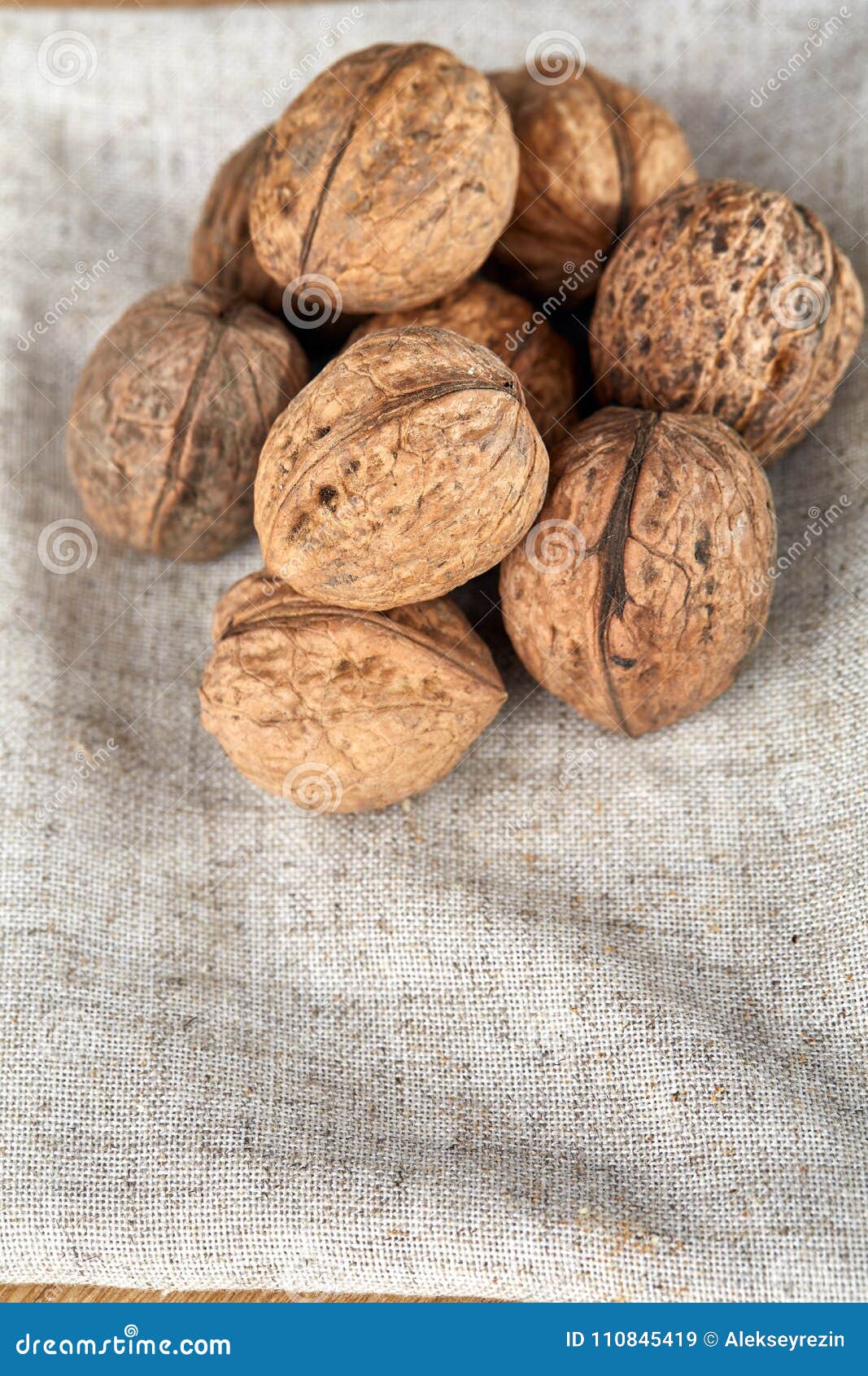 A Stack of Walnuts Piled Together and on Rustic Wooden Background ...