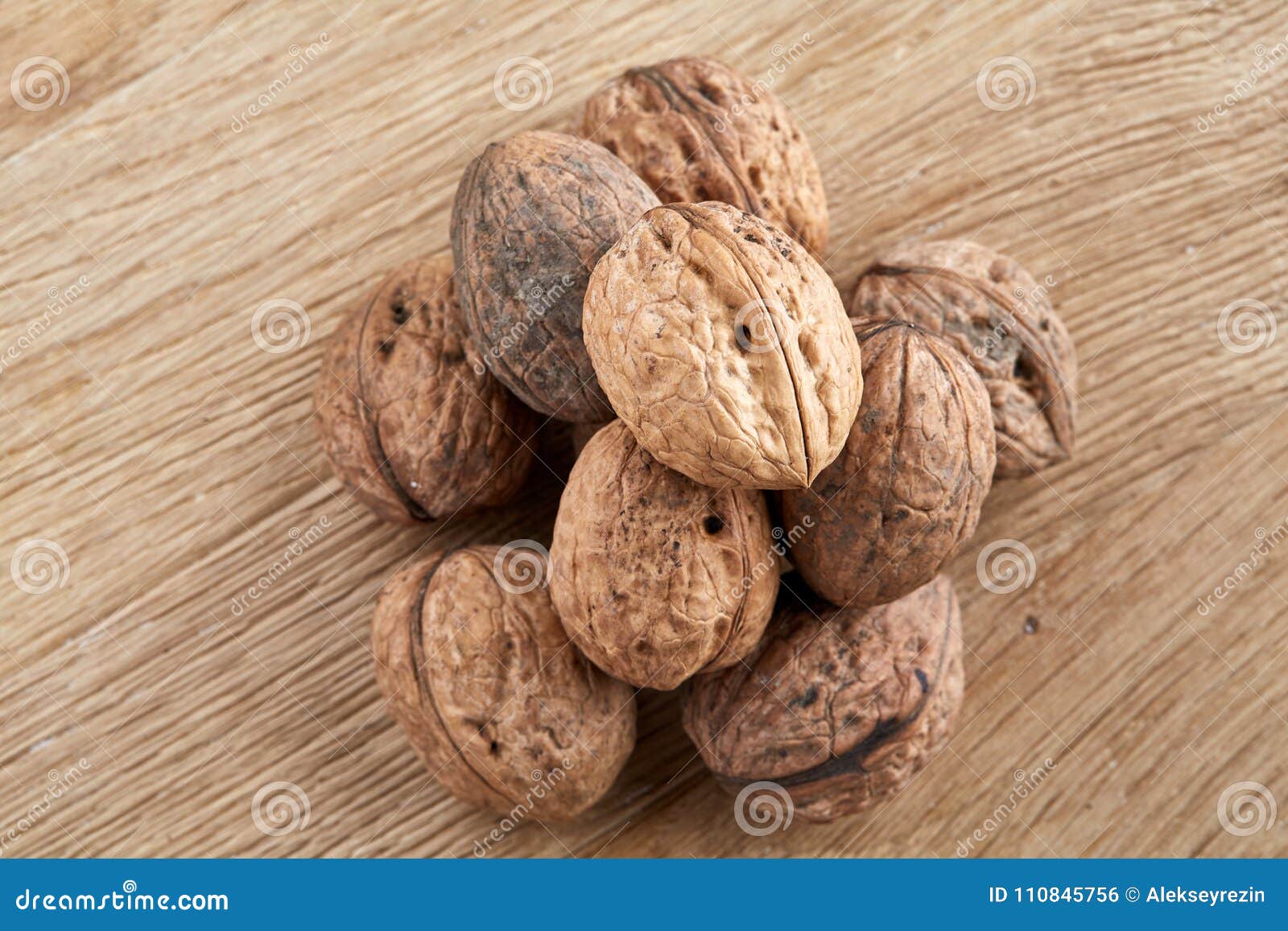 A Stack of Walnuts Piled Together and on Rustic Wooden Background ...