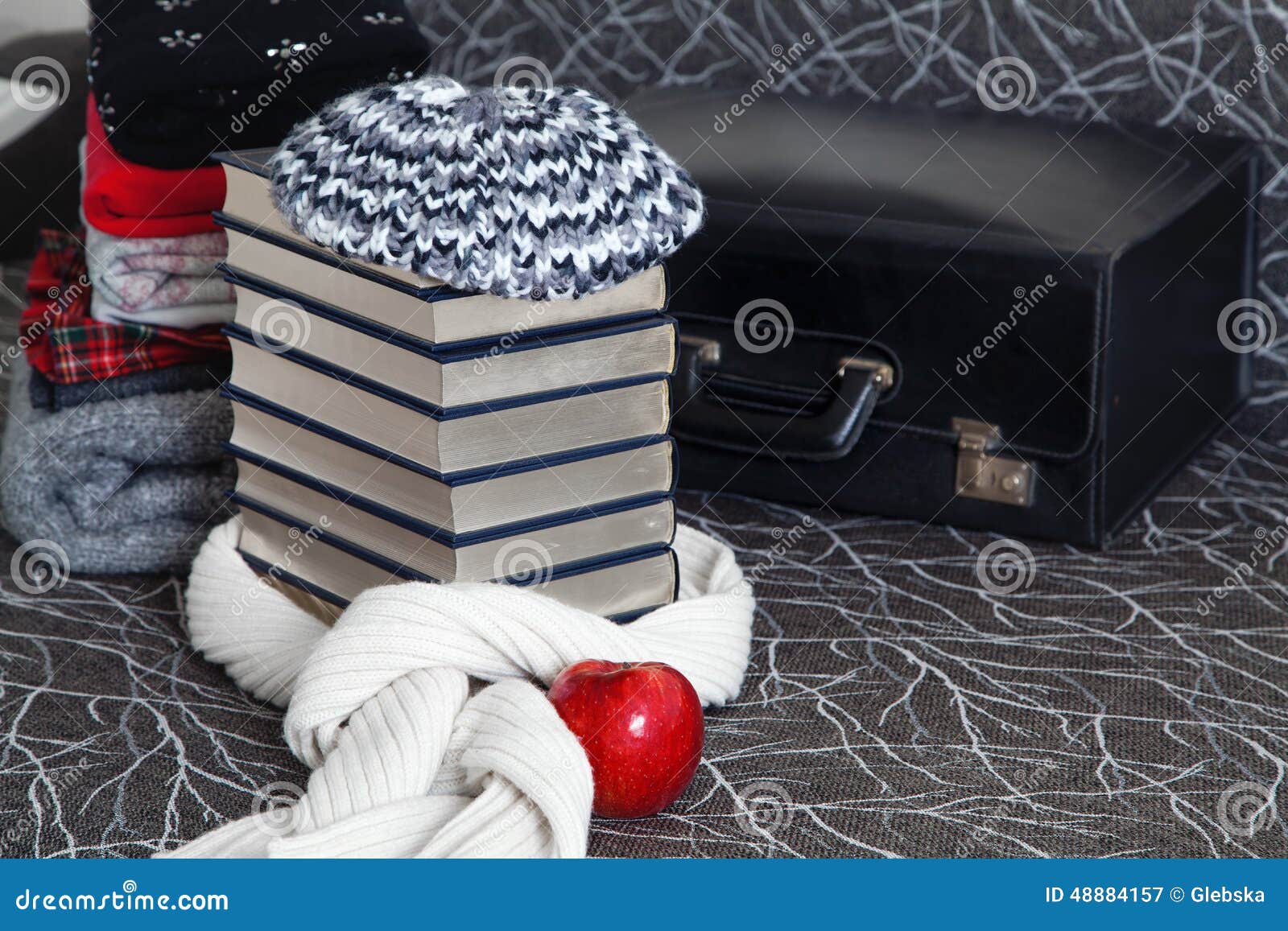Stack of Winter Clothes and Books with Glossy Edge Stock Image - Image ...