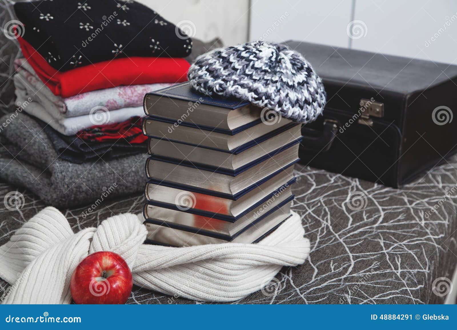 Stack of Winter Clothes and Books with Glossy Edge Stock Image - Image ...