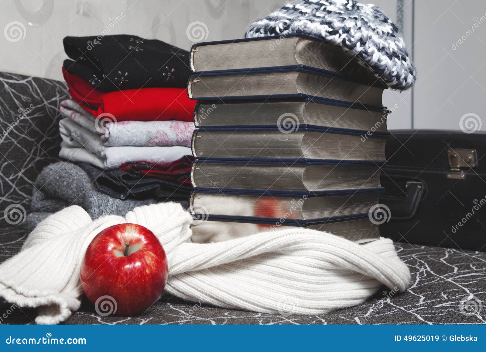 Stack of Winter Clothes and Books with Glossy Edge Stock Image - Image ...