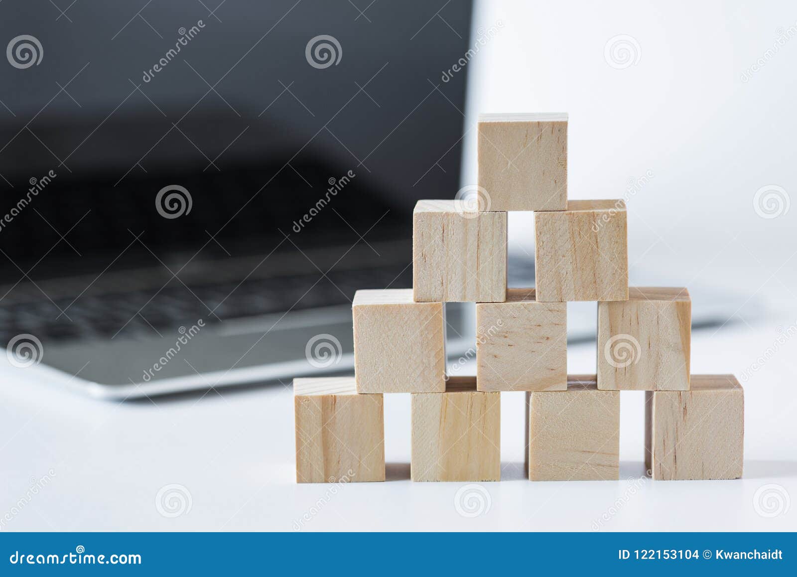 Stack of Wood Cube Building Blocks with Laptop Computer Backgro Stock ...