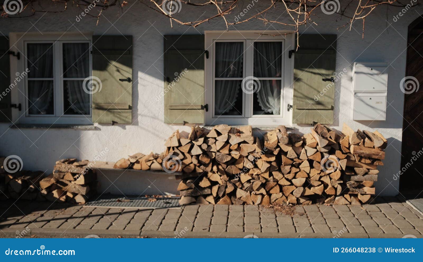 Stack of Wood Near the Wall of a White Rural House Stock Photo - Image ...