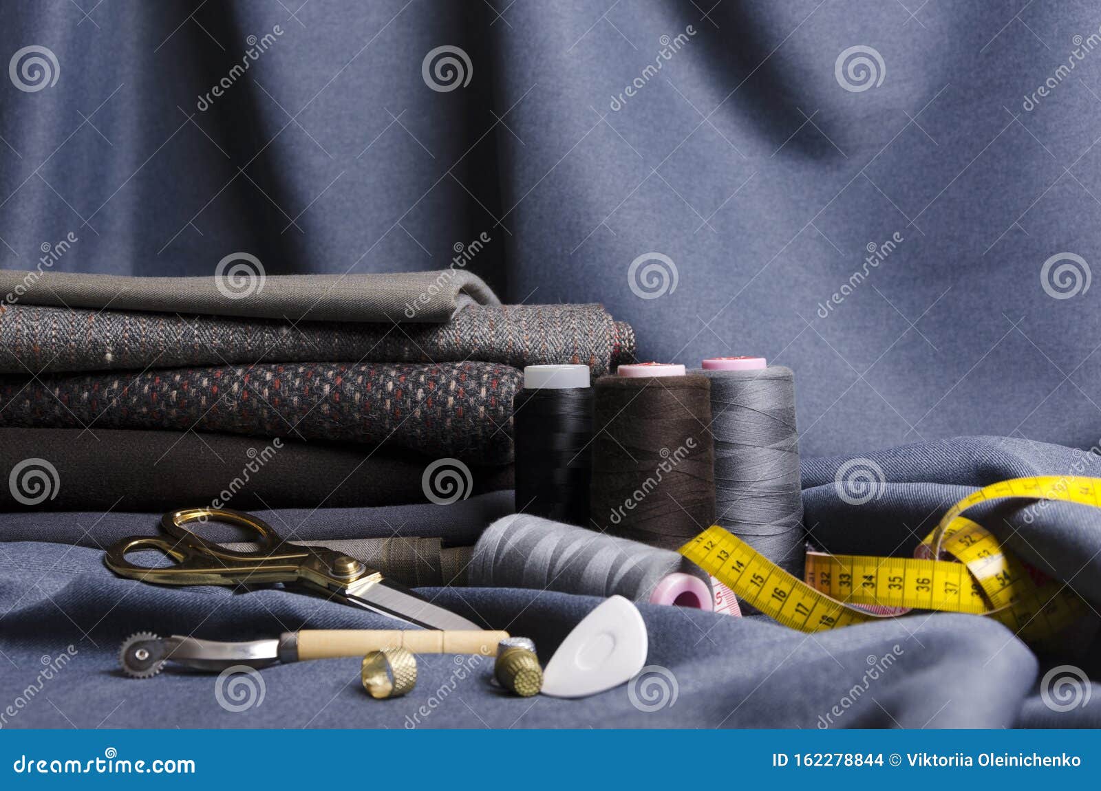 Stack of Woolen Fabric, Tailor`s Tools on the Blue Fabric Background ...