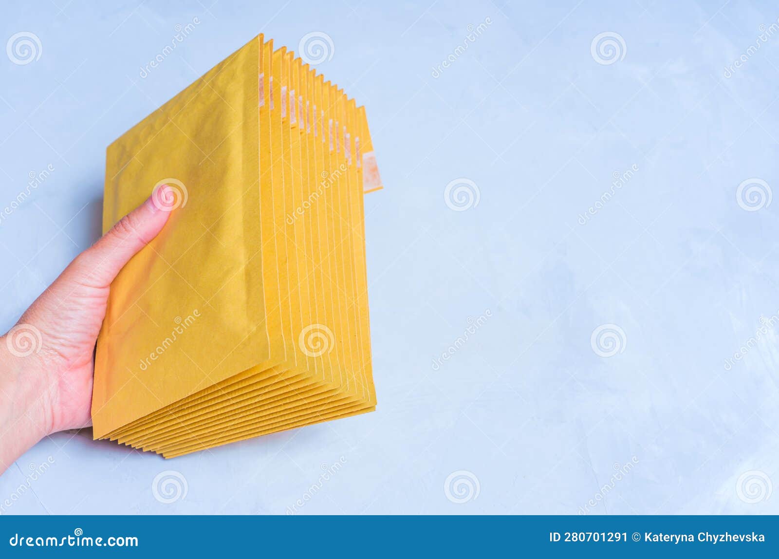 Stack of Yellow Padded Envelopes in Hand Stock Image - Image of ...