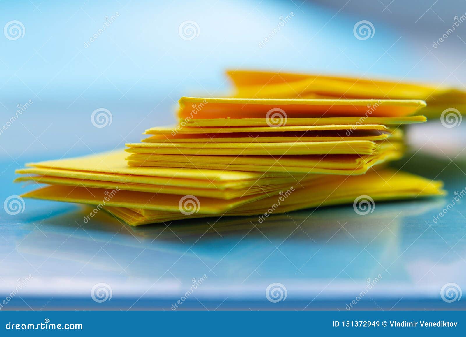 Stack of Yellow Paper on Blue Table Stock Image - Image of finance ...
