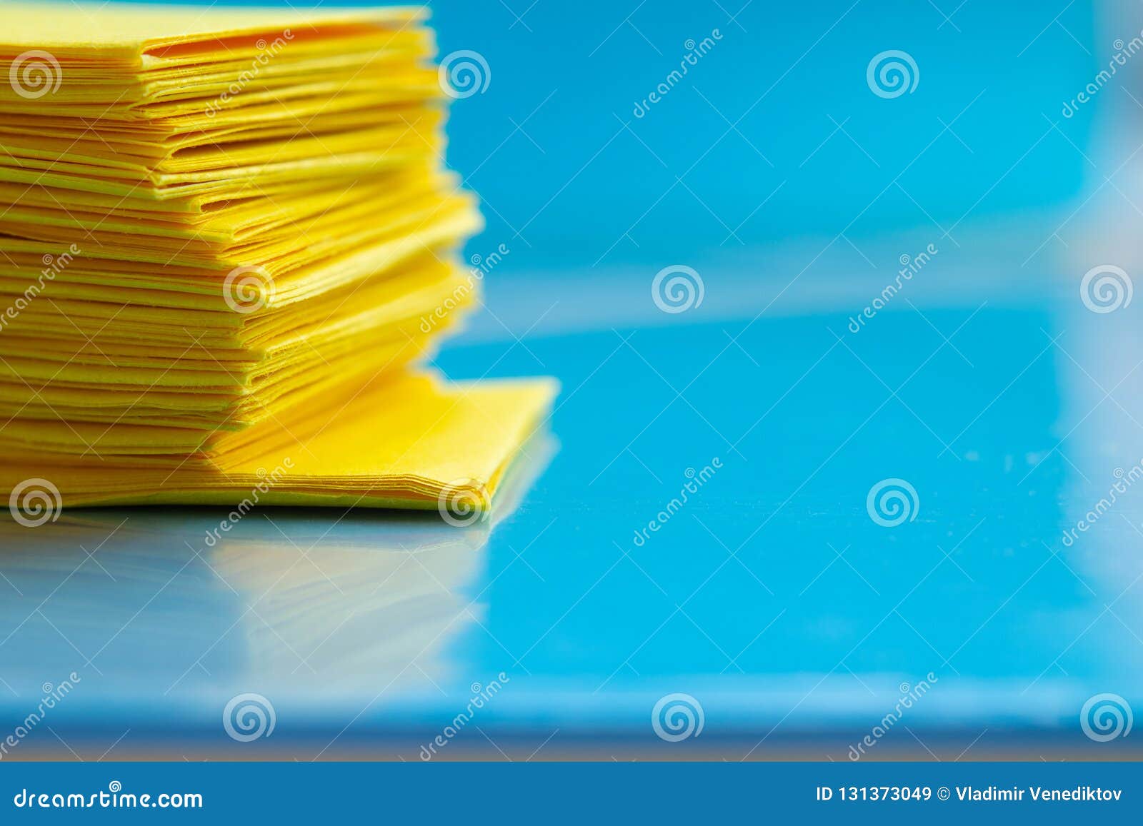 Stack of Yellow Paper on Blue Table Stock Image - Image of corporate ...