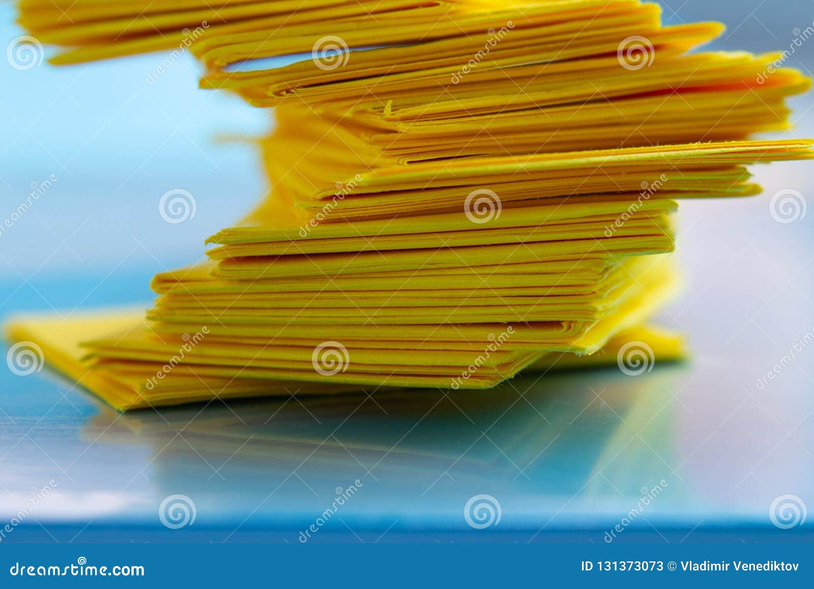 Stack of Yellow Paper on Blue Table Stock Image - Image of accounting ...