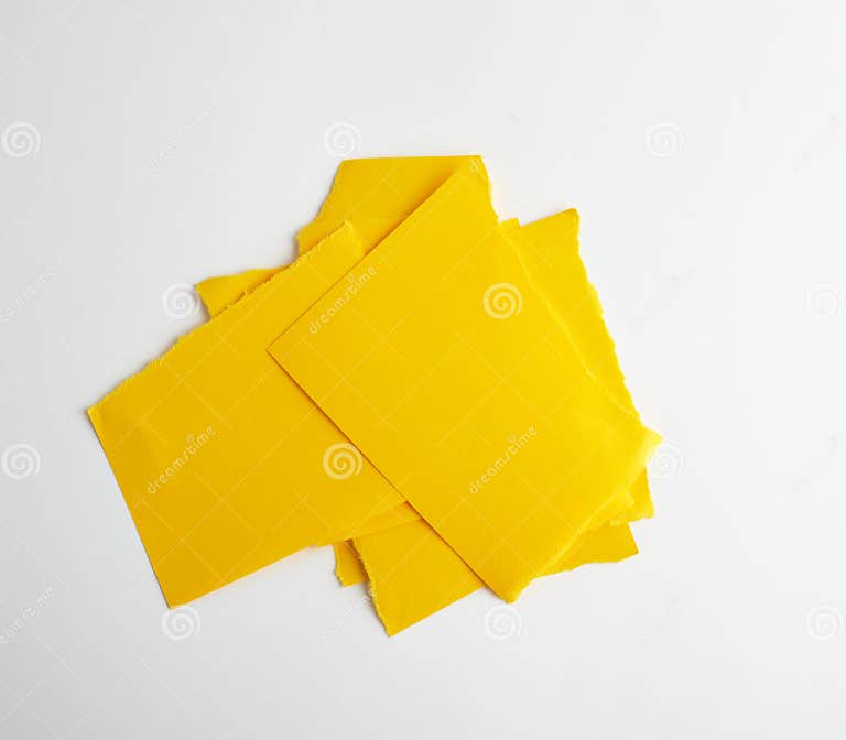 Stack of Yellow Paper Torn Pieces of Paper on a White Background Stock ...