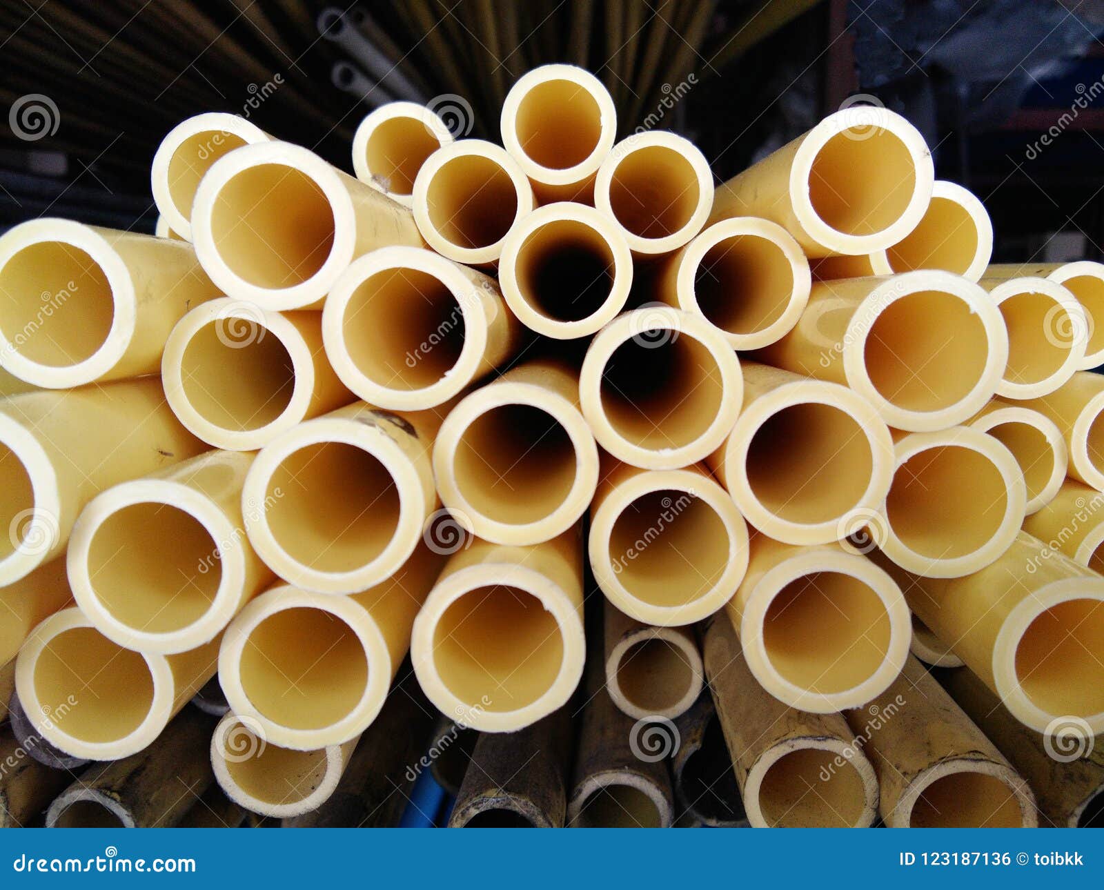 Stack of yellow pvc pipes stock photo. Image of pattern - 123187136