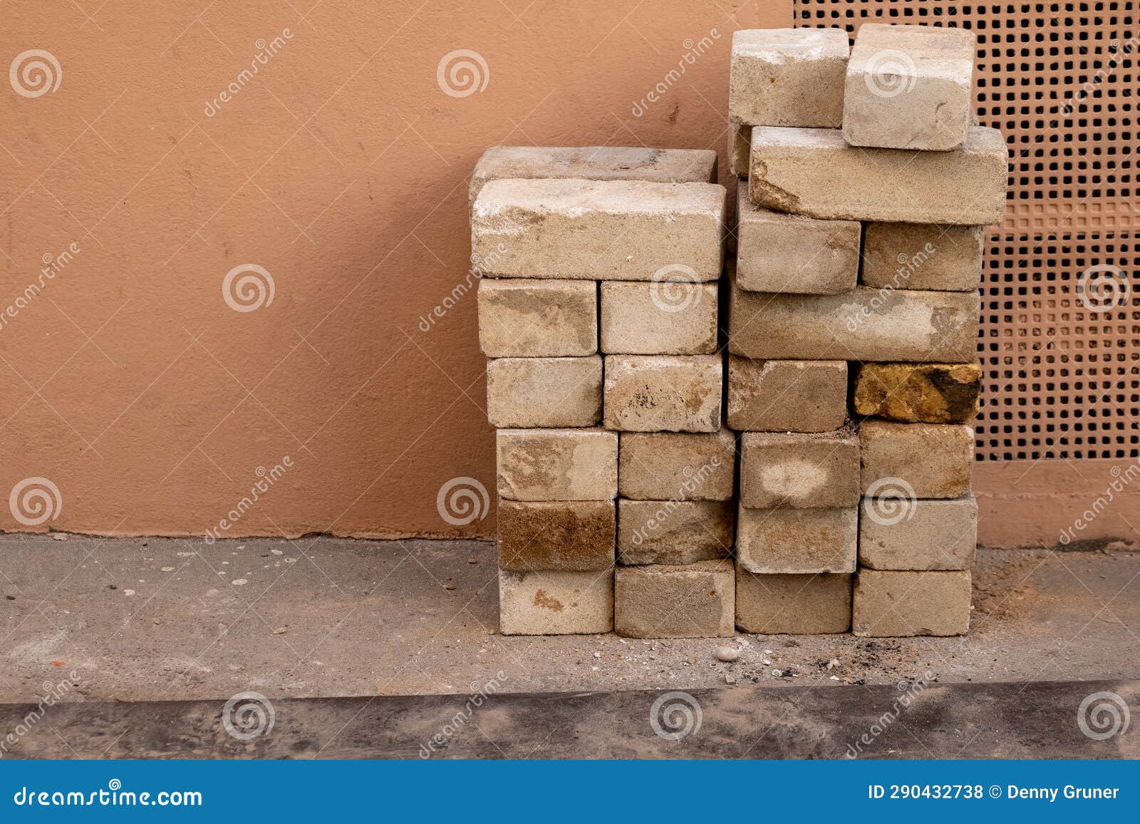 Stacked Bricks in Front of a House Wall Stock Photo - Image of ...