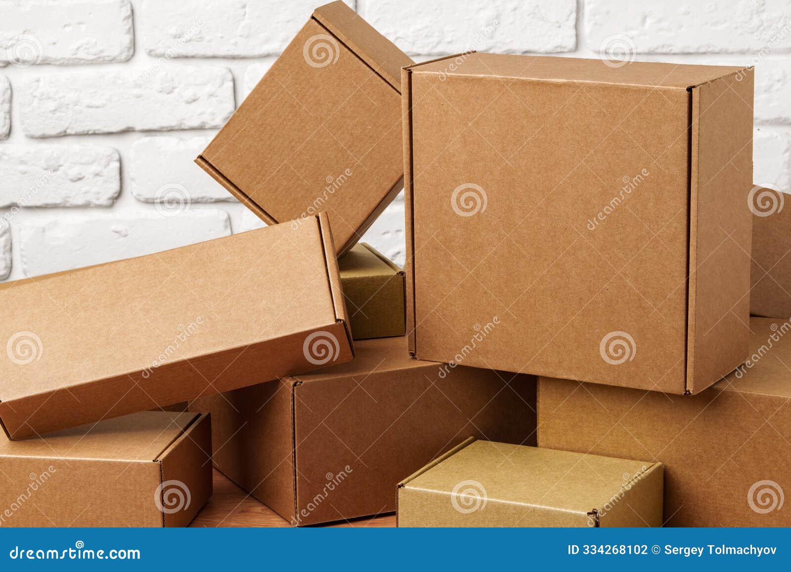 Stacked Cardboard Boxes Against a White Brick Wall Close Up Stock Photo ...