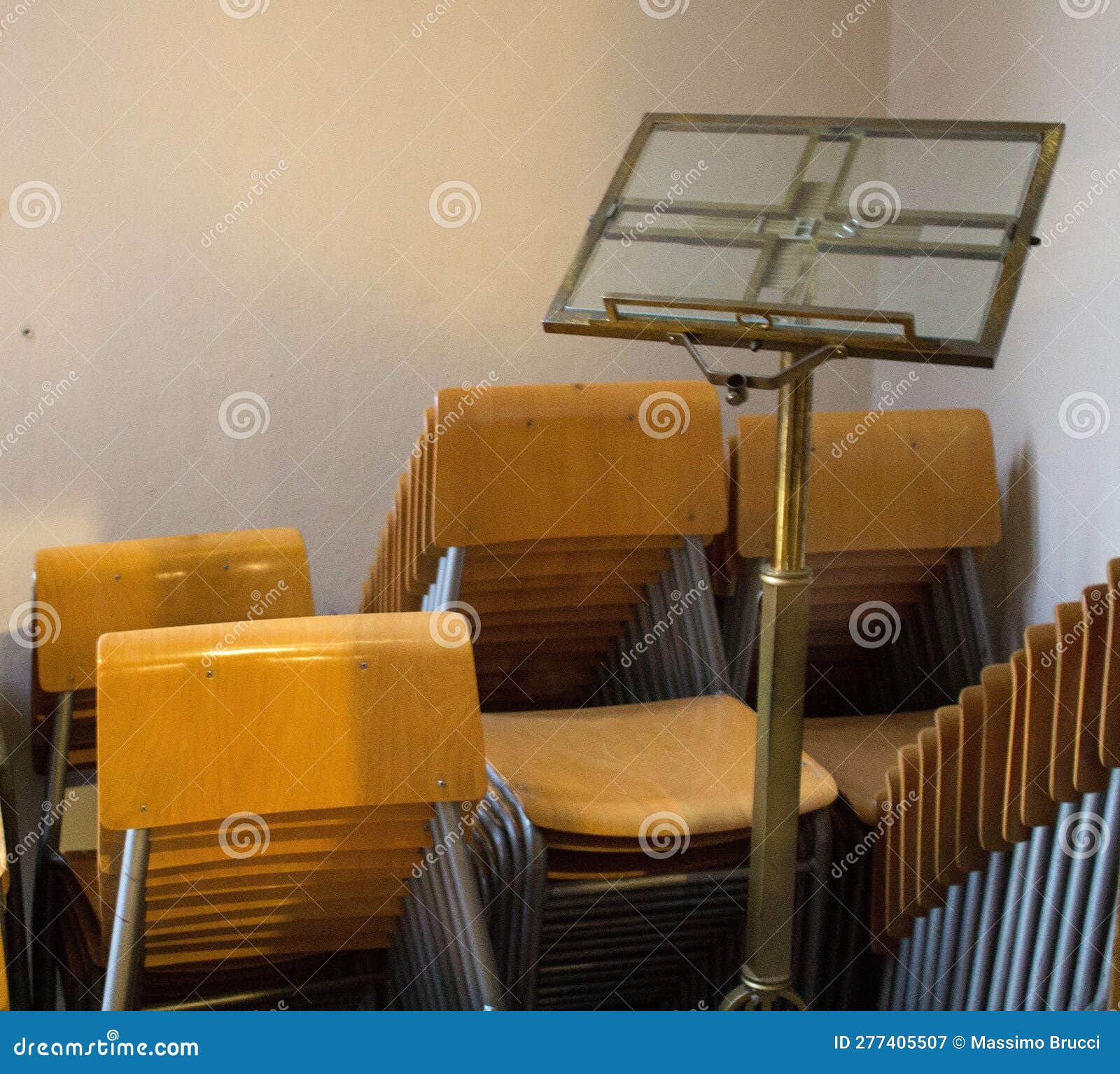Stacked Chairs with a Lectern beside Them Stock Image - Image of ...