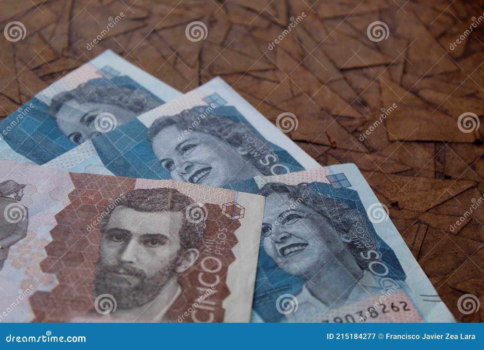 Stacked Colombian Banknotes of Different Denomination on the Brown ...