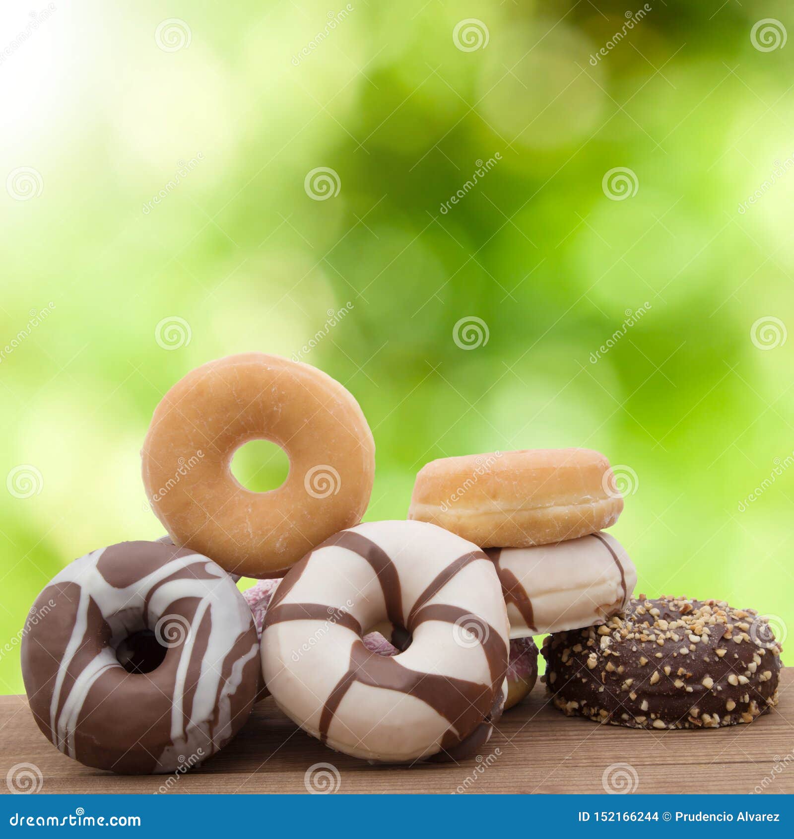 Stacked donuts in wood stock photo. Image of food, bakery - 152166244