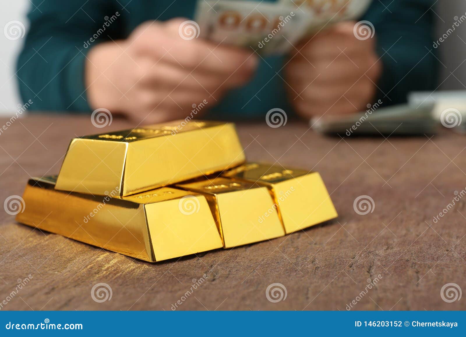 Stacked Gold Bars and Man Counting Money at Table Stock Photo - Image ...