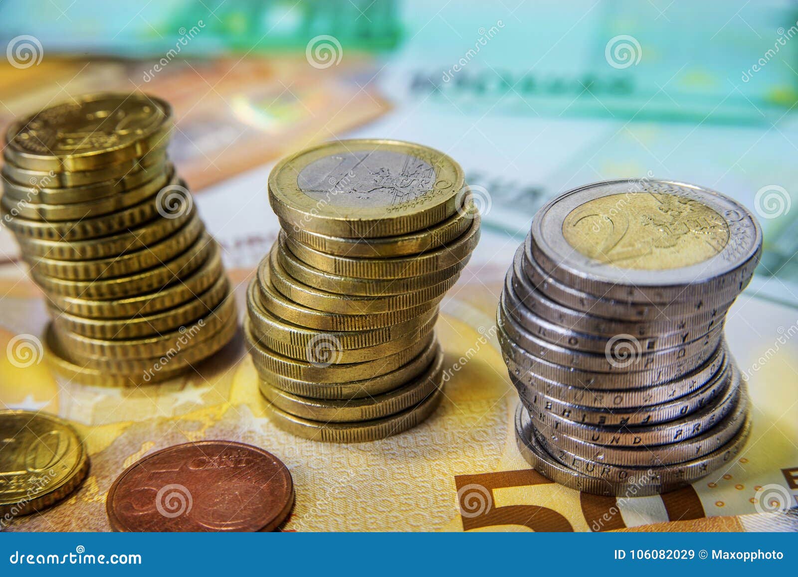 Stacked One and Two Euro Coins with Paper Banknotes Stock Image - Image ...