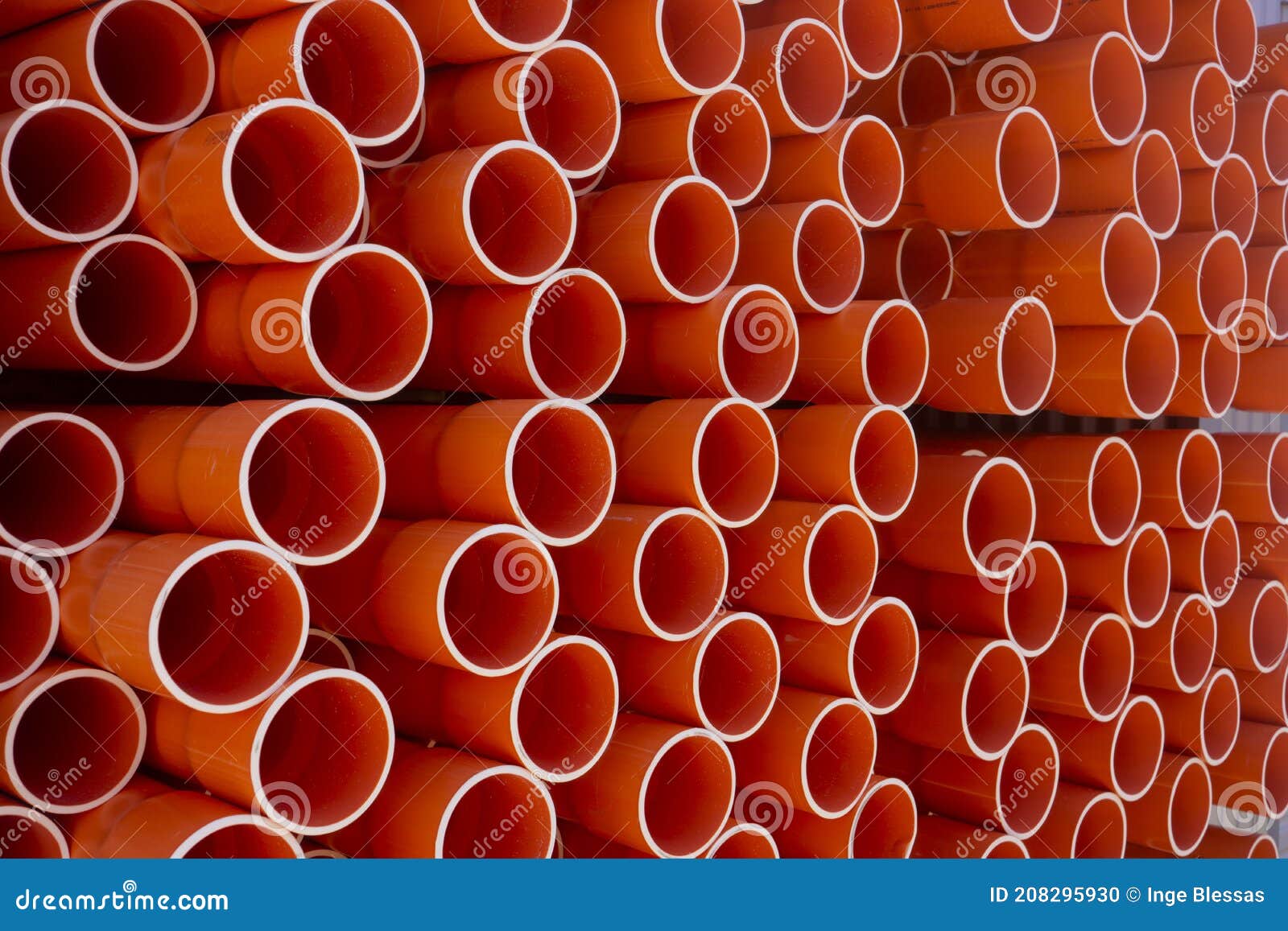 Stacked Orange Electrical Conduit Pipes Making a Pattern of Circles ...