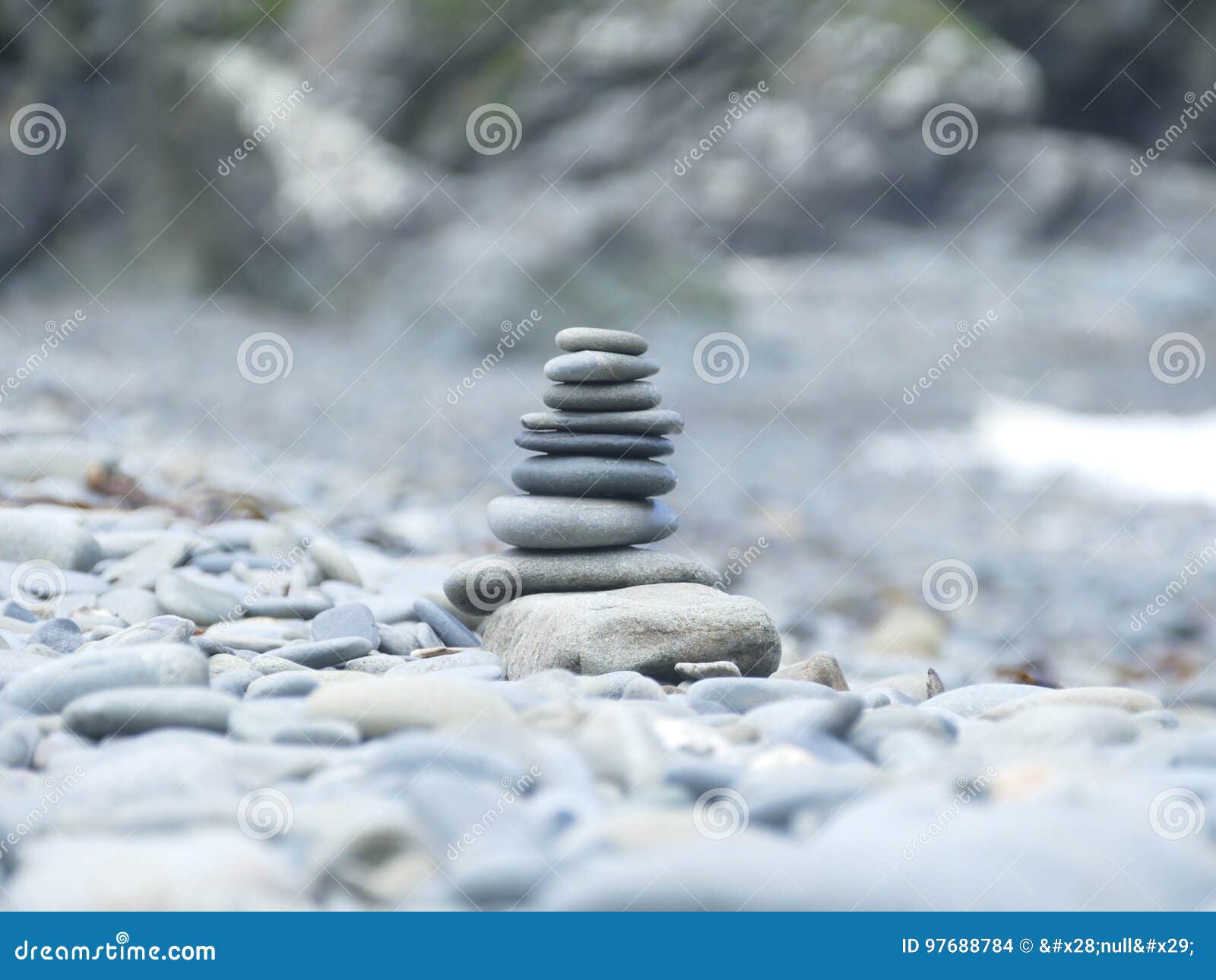 Stacked pebbles on a beach stock photo. Image of beach - 97688784