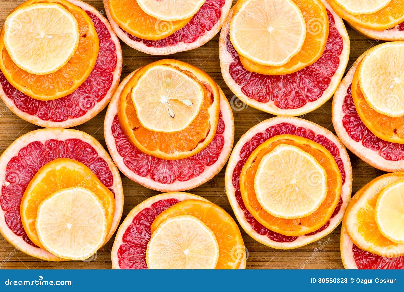 Stacked Red Grapefruit, Orange and Lemon Slices Stock Photo - Image of ...