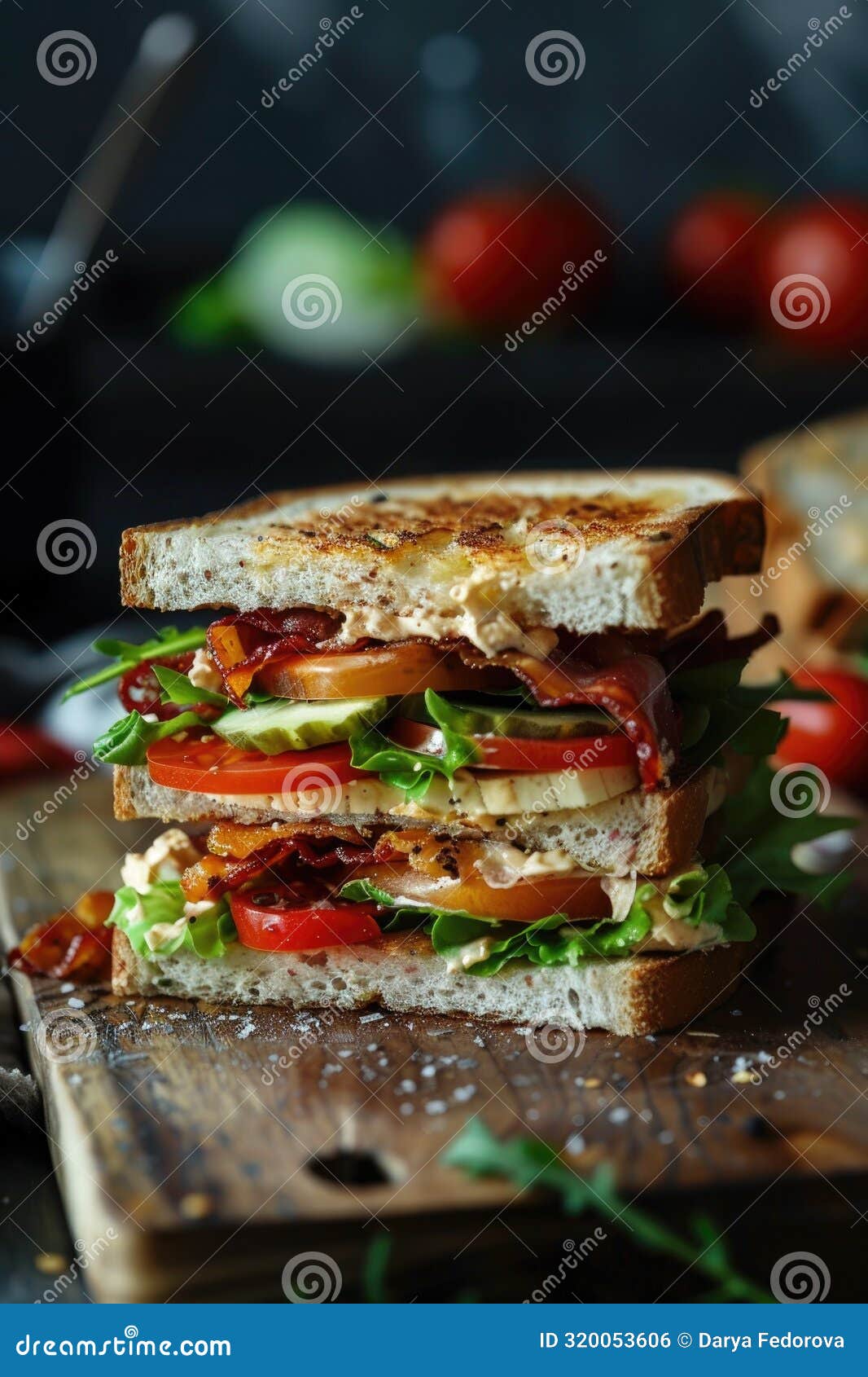 Stacked Sandwich with Fresh Vegetables, Ham, and Cheese Against Black ...