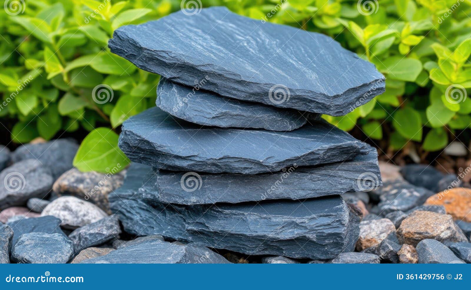 Stacked Slate Stones in Garden Setting with Green Foliage Background ...