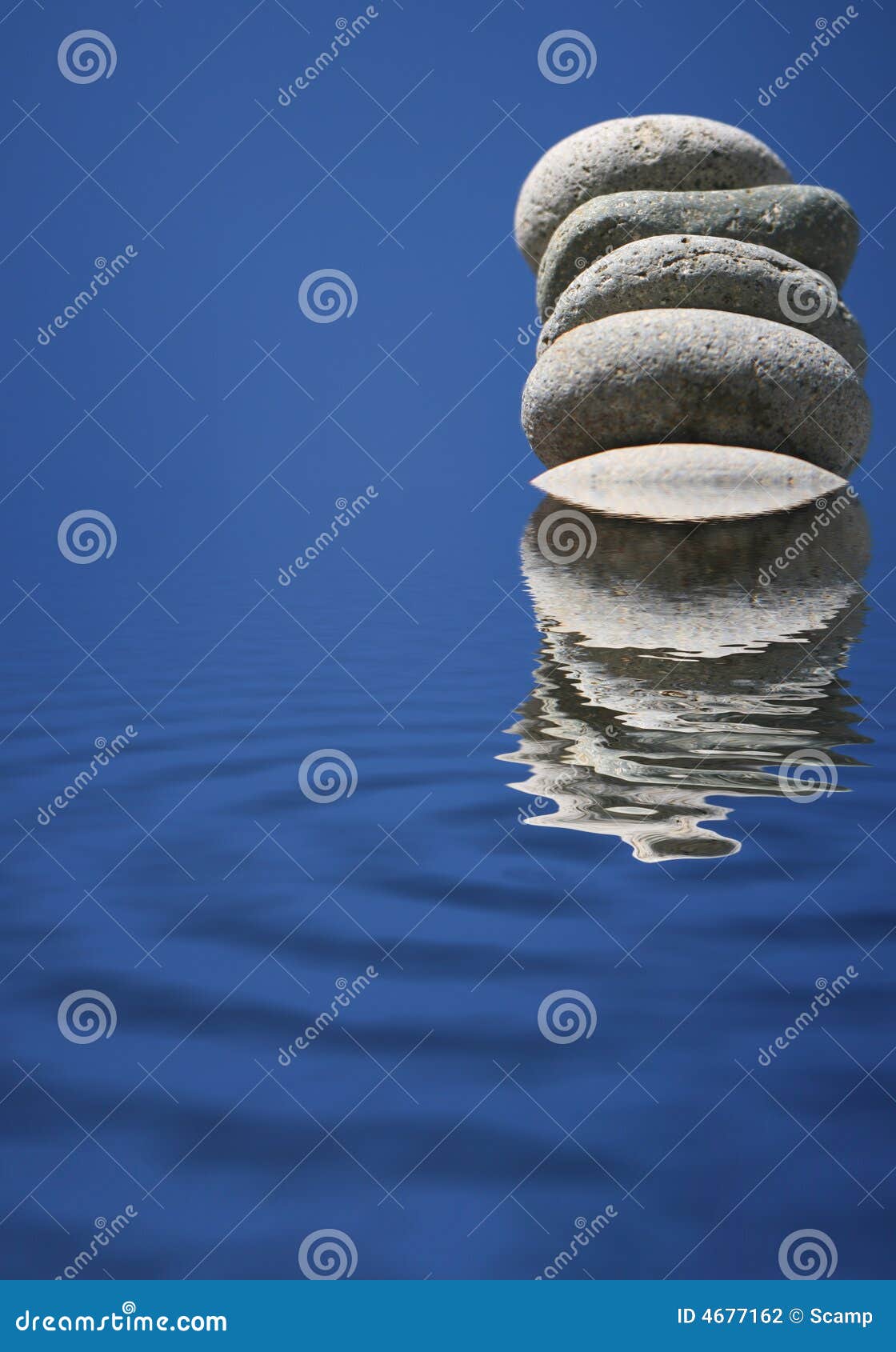 Stacked Stones Refelcting in Blue Water Stock Photo - Image of ...