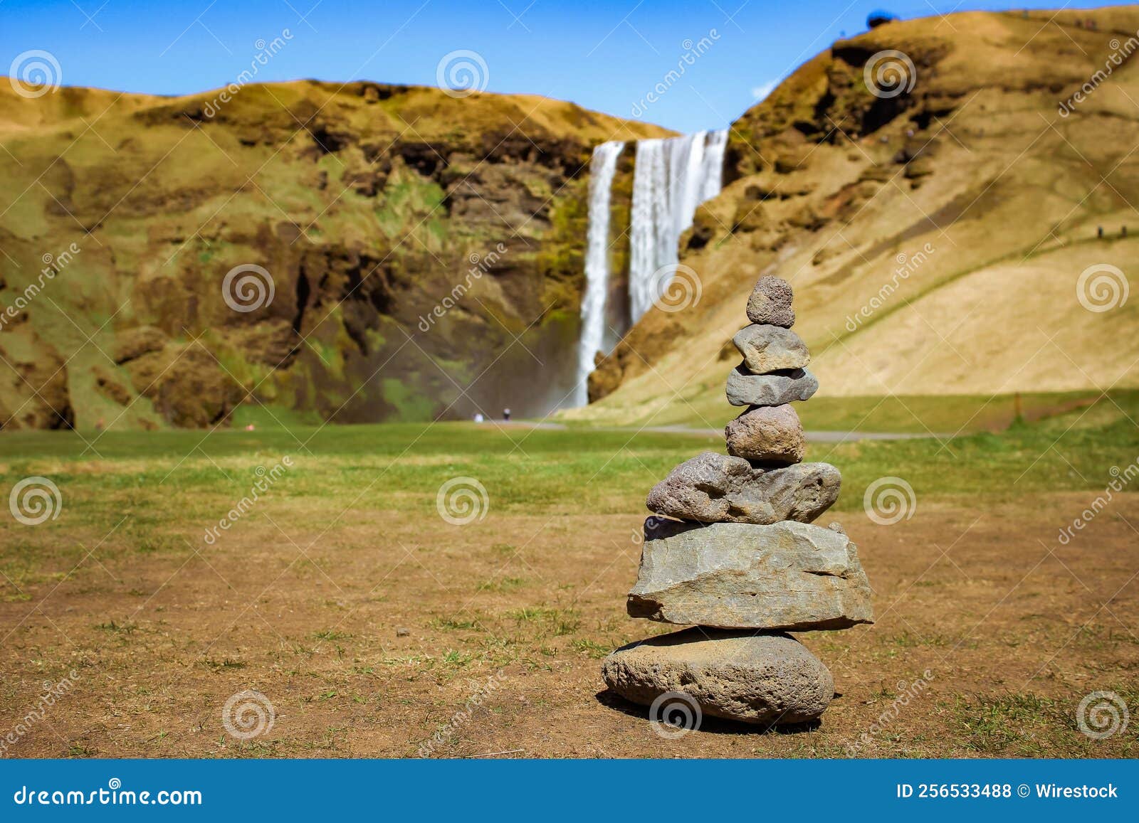 Stacked Stones and the Waterfall in the Background Stock Photo - Image ...
