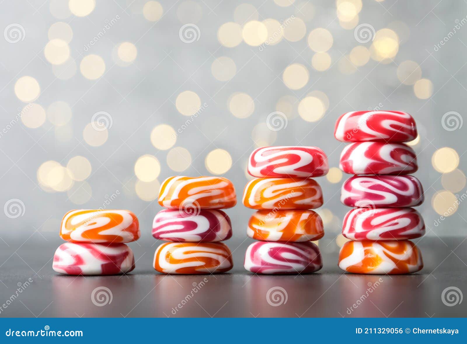 Stacked Tasty Hard Candies on Grey Table Stock Photo - Image of blurred ...
