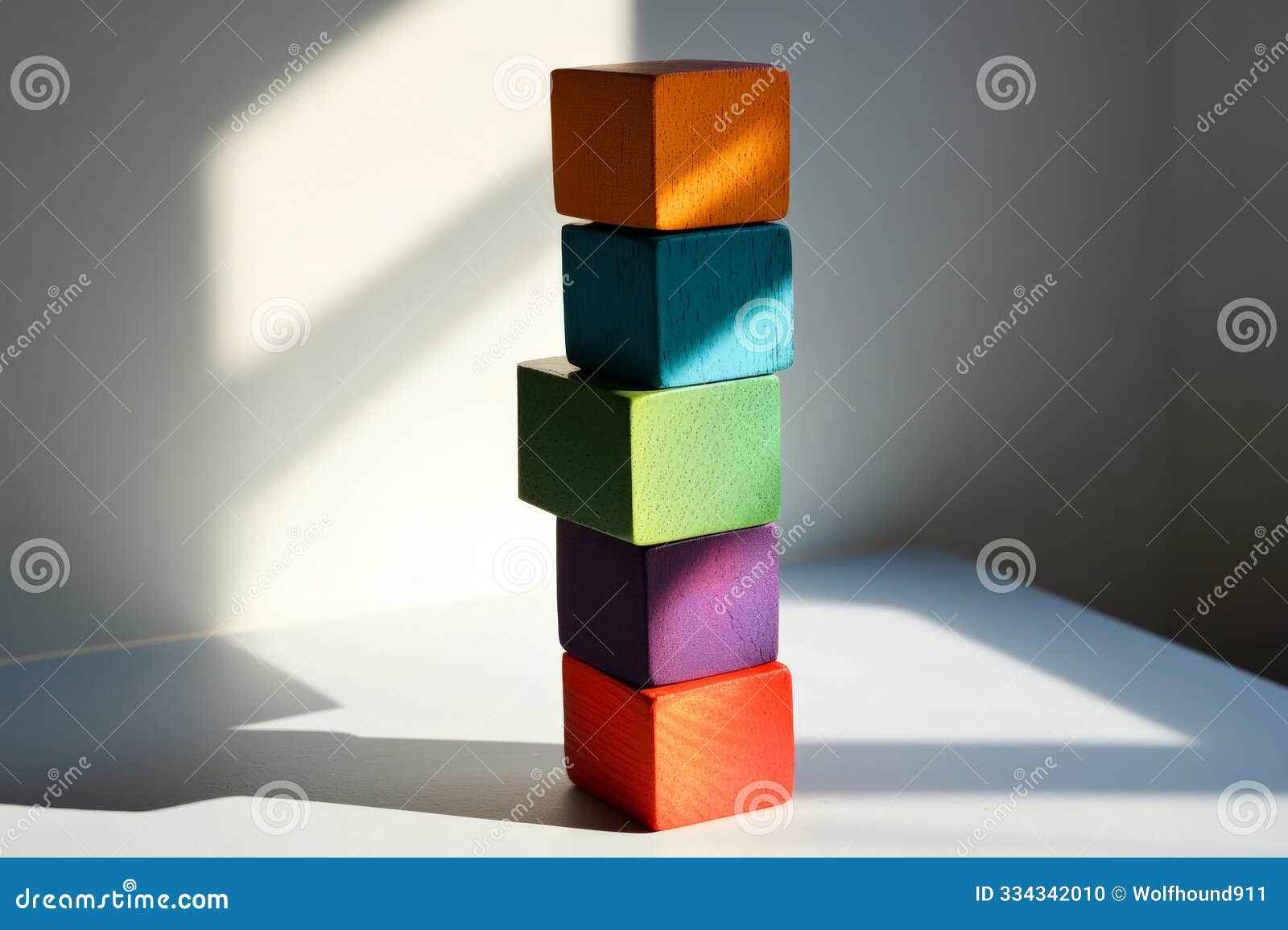 A Stacked Tower of Multi-colored Cubes on a Light Gray Surface, with ...