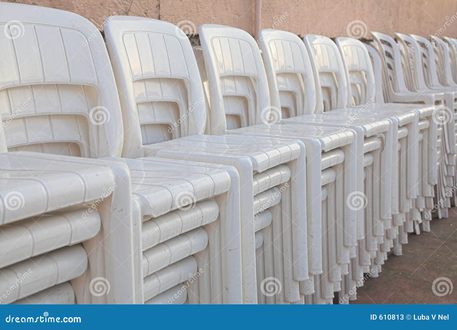 Stacked white chairs stock image. Image of plastic, evening - 610813