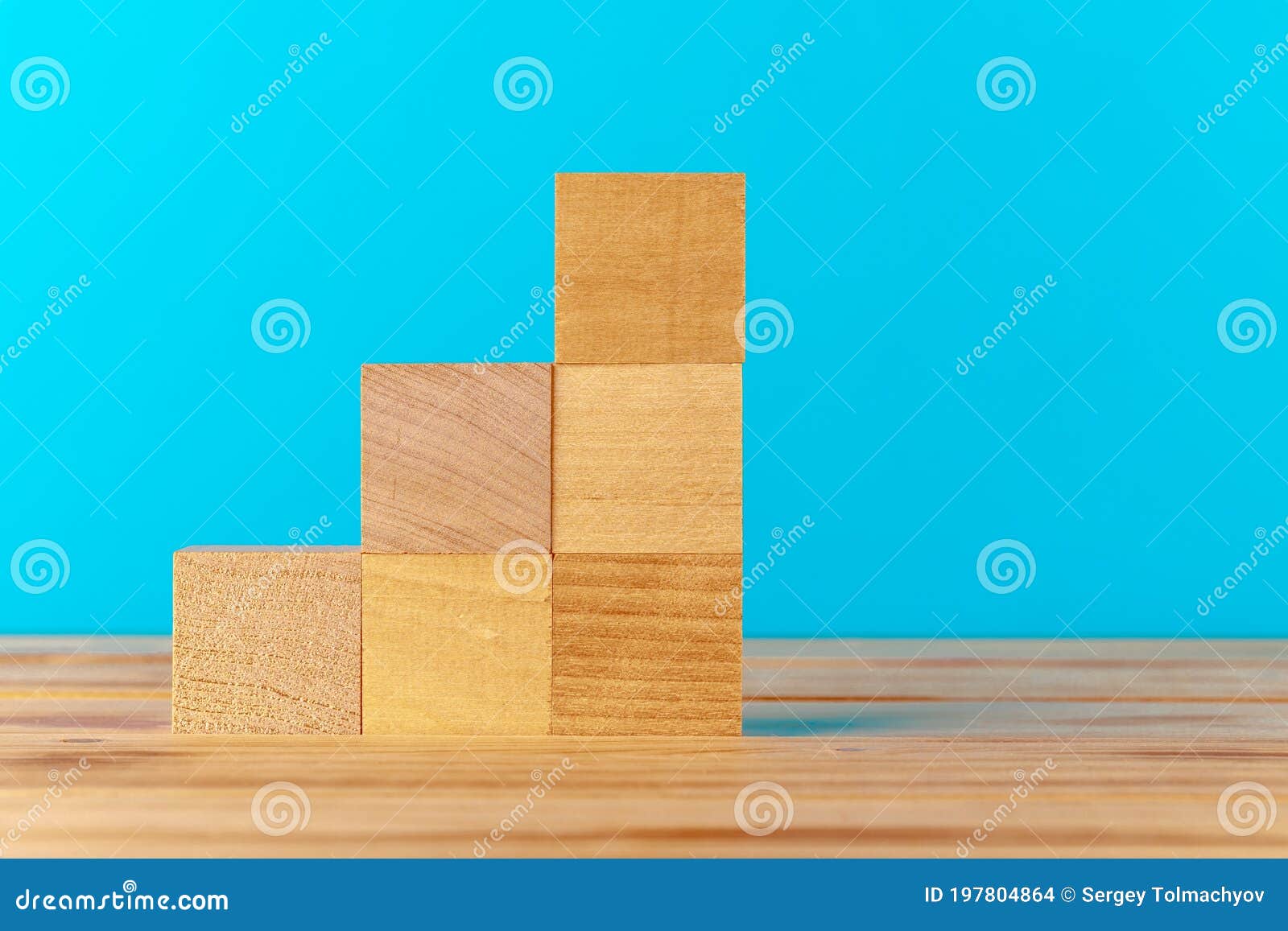 Stacked Wooden Blocks on Wooden Desk Against Blue Background Stock ...