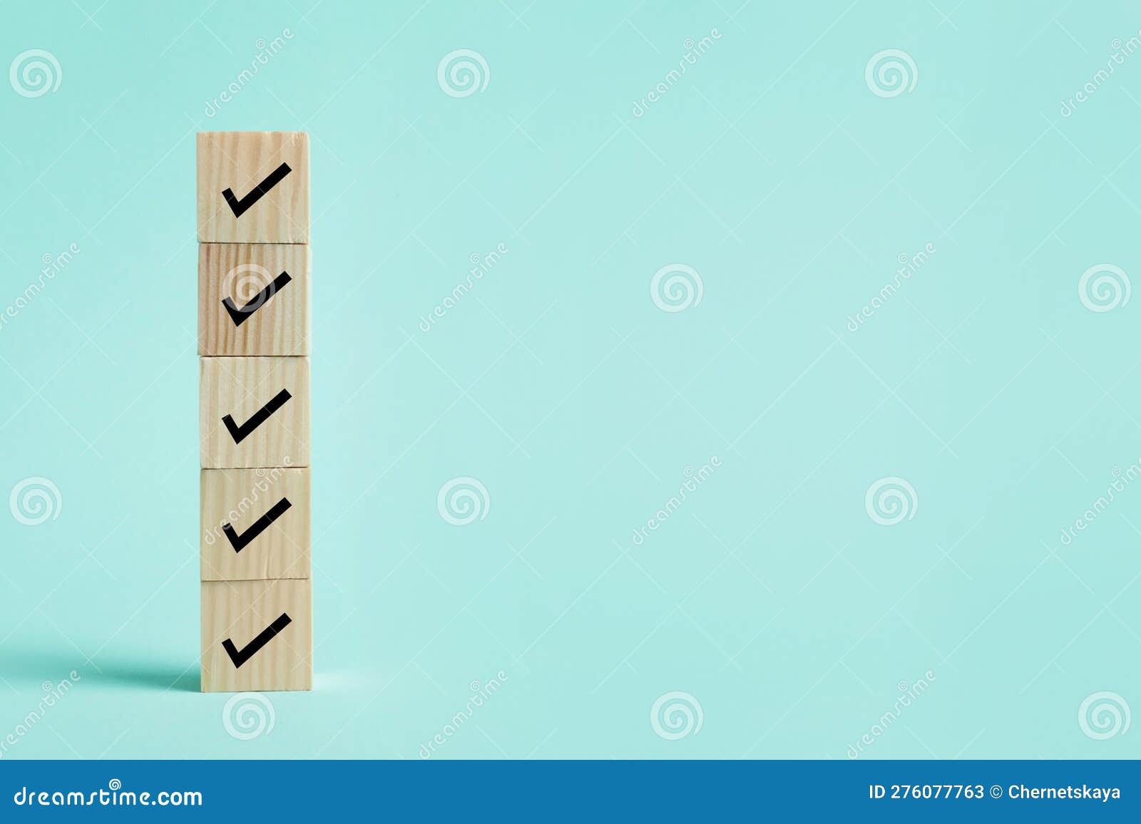 Stacked Wooden Cubes with Check Marks on Turquoise Background. Space ...